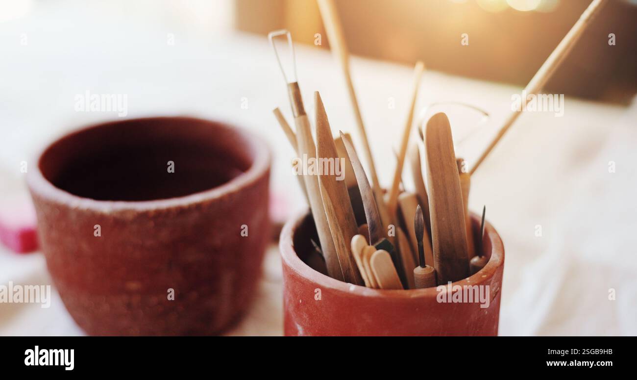 Pottery, art and cup with tools at workshop for sculpture art, creative ...