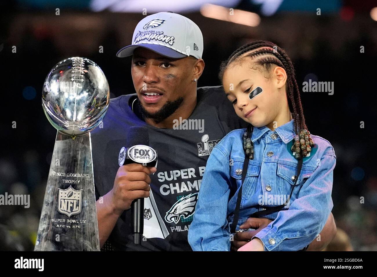 Philadelphia Eagles running back Saquon Barkley holds his daughter Jada ...