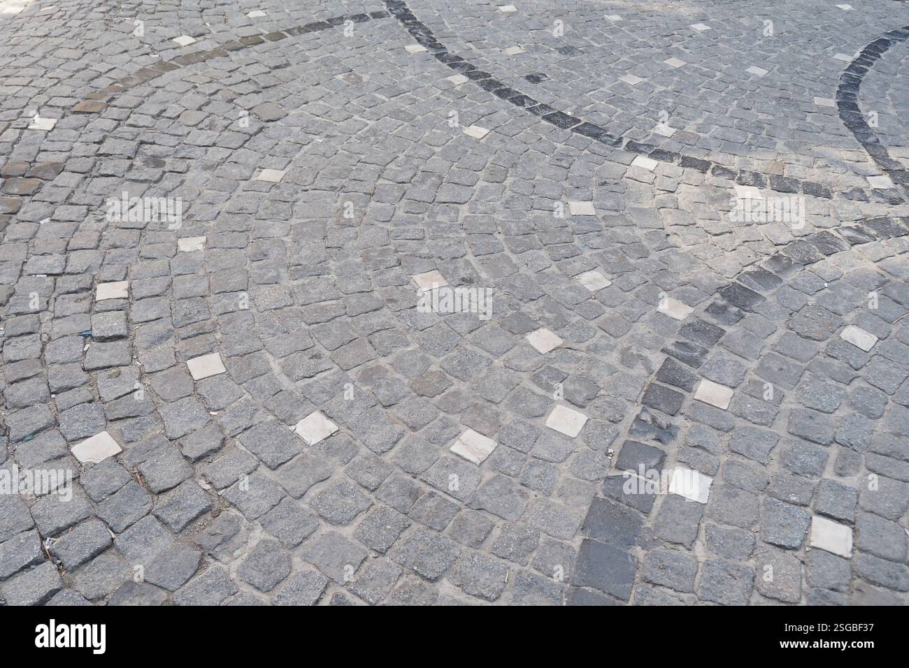 Cobblestone pathway showcases intricate patterns in a quaint location ...