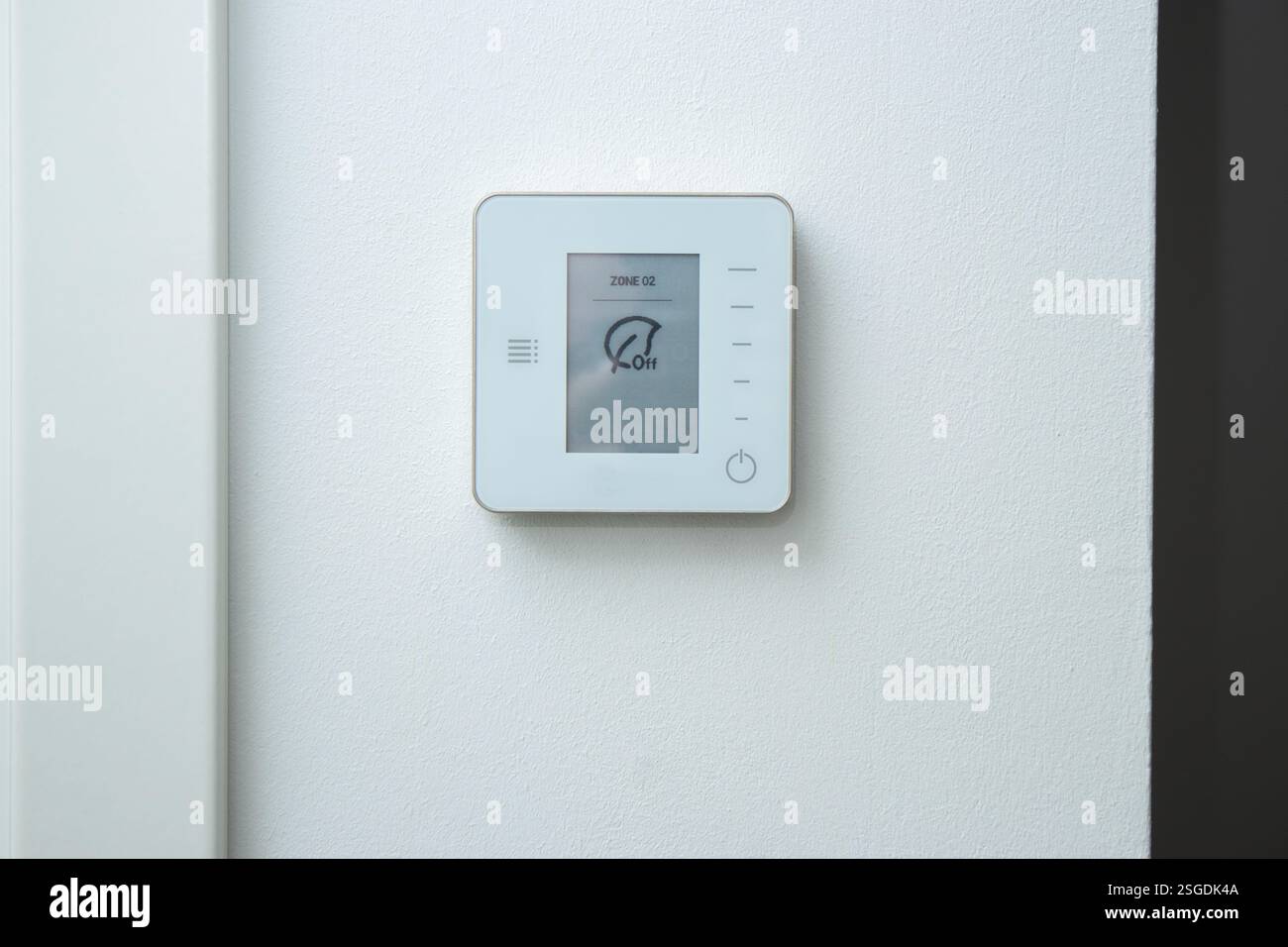 A modern electric thermostat control system on white wall Stock Photo ...