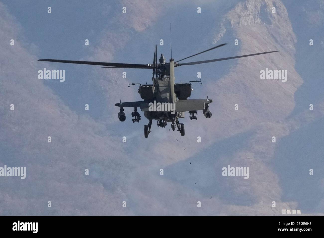 A U.S. Army AH-64 Apache helicopter fires during a combined live fire ...
