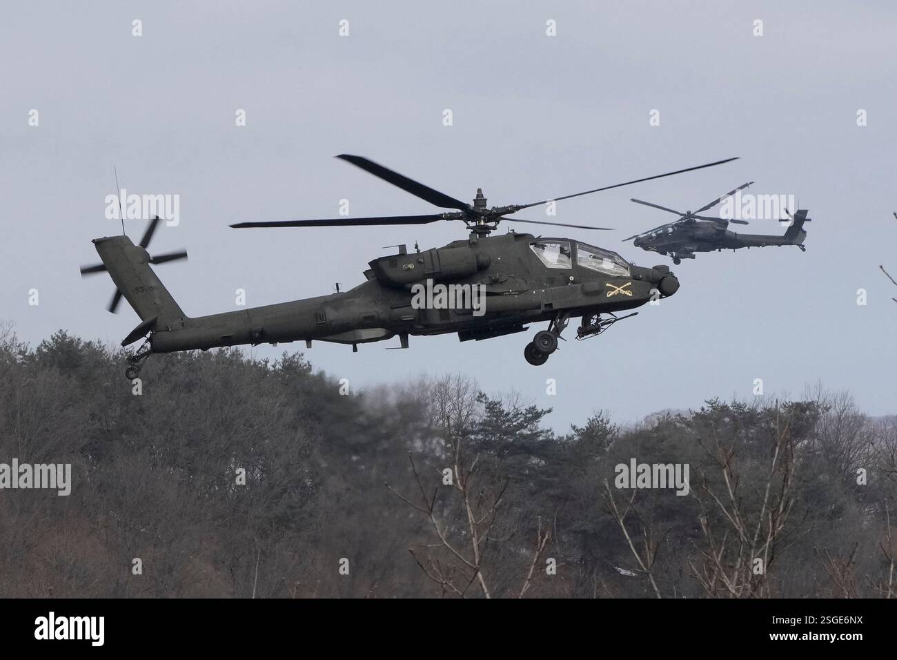 U.S. Army AH-64 Apache helicopters fly during a combined live fire ...