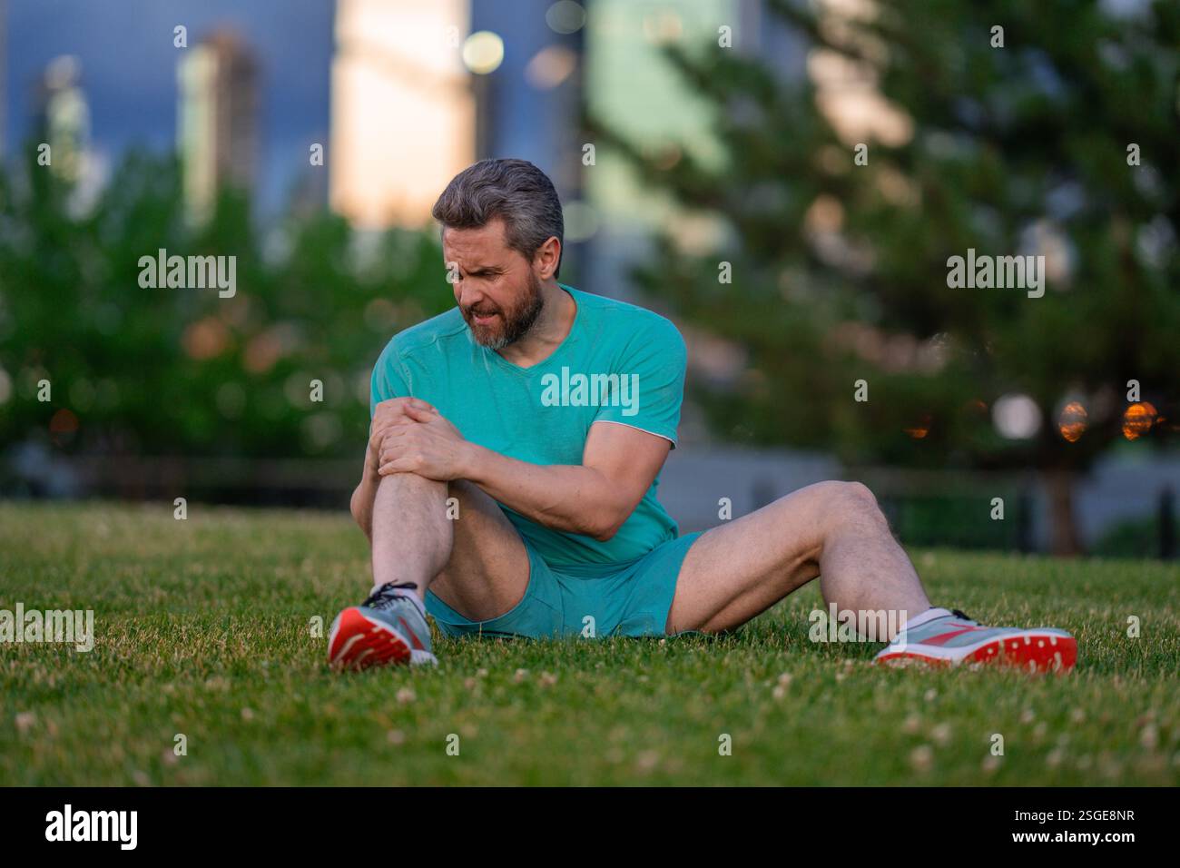 Knee after sport. Man struggling with leg pain. Injured man holding ...