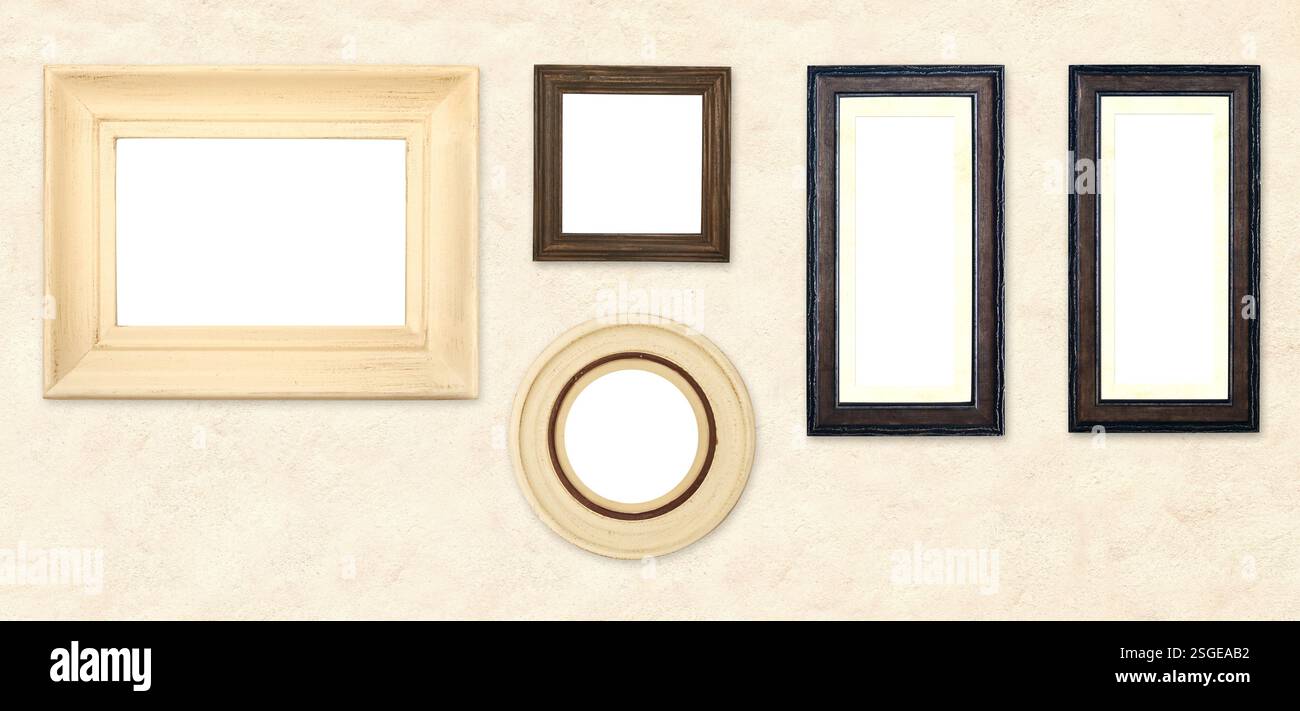 Horizontal banner with blank picture frames hanging on stucco wall ...
