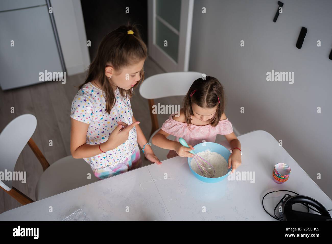 Children baking together in a modern kitchen setting Stock Photo - Alamy