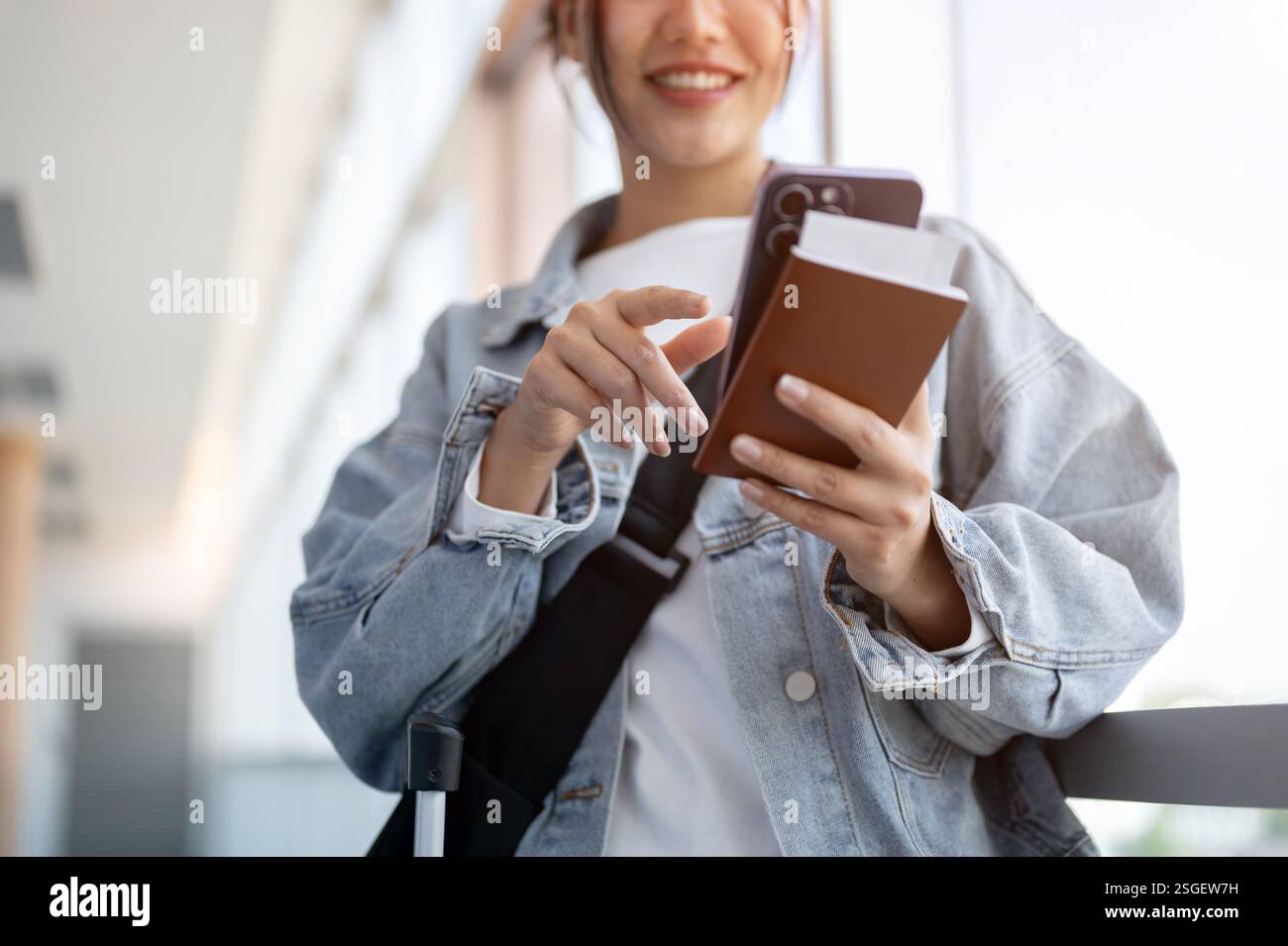 A close-up of an Asian female passenger waiting for her flight boarding ...