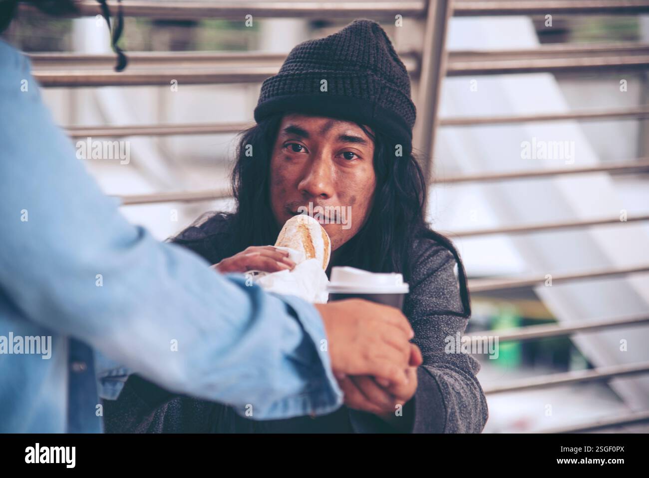 Woman helping hands to homeless people poverty beggar man holding hands asking for money job and ...