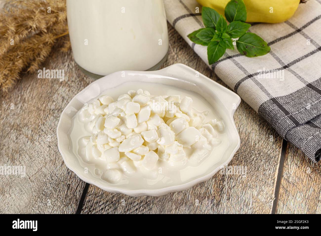 Grain cottage cheese with sour in the bowl Stock Photo - Alamy