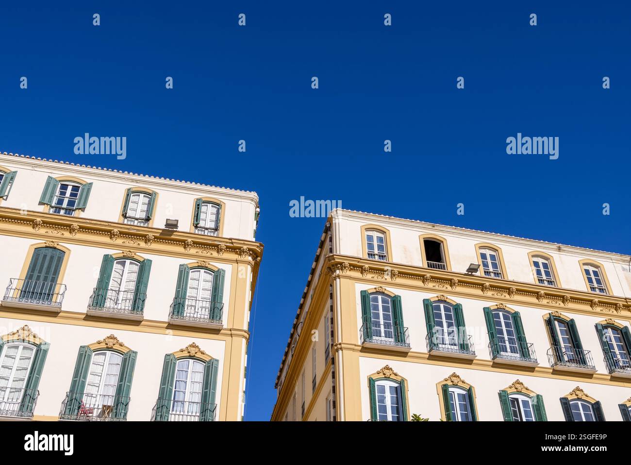 Photo of the top of historical Spanish buildings in the city of Malaga ...