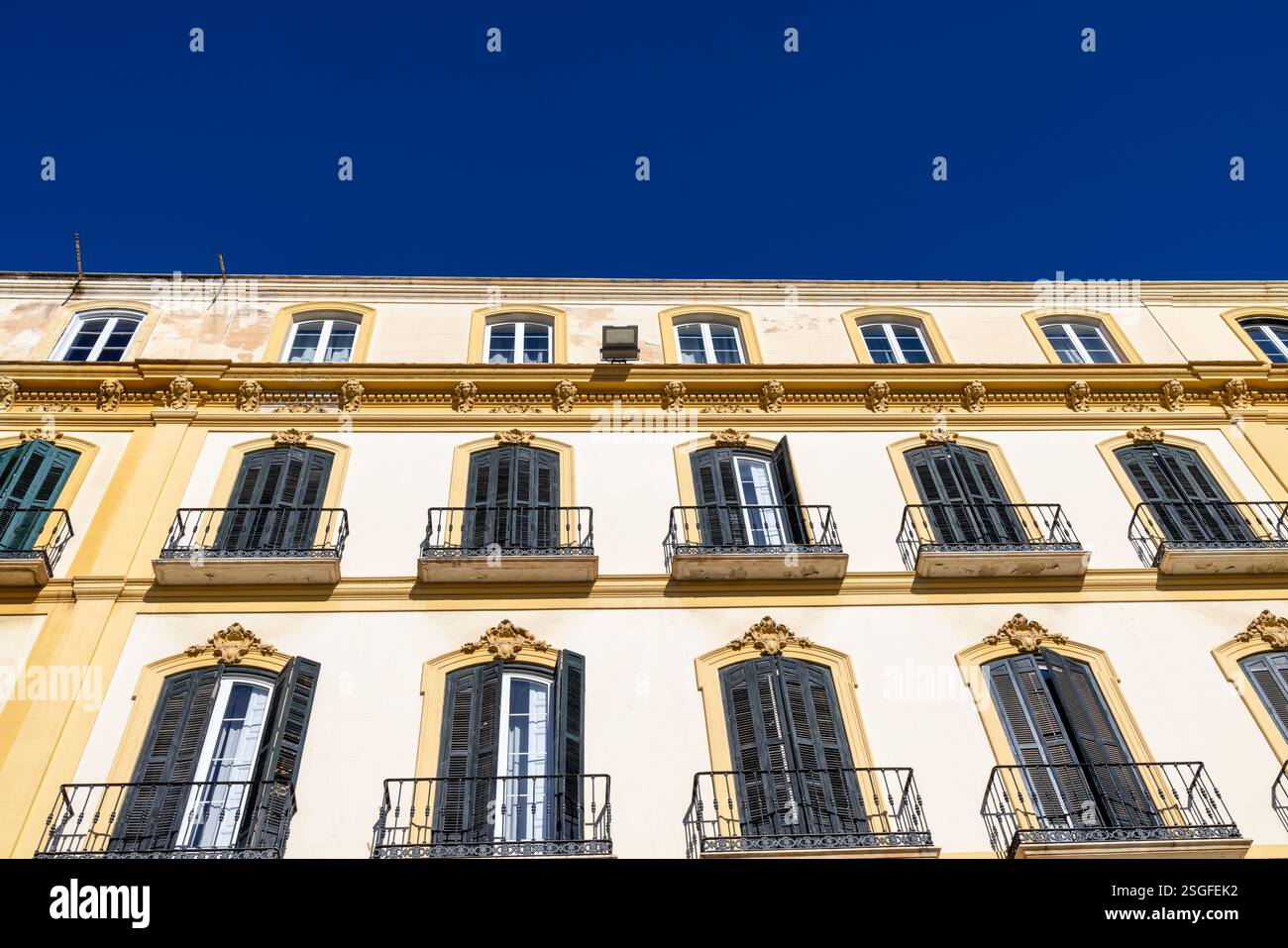 Photo of the top of historical Spanish buildings in the city of Malaga ...