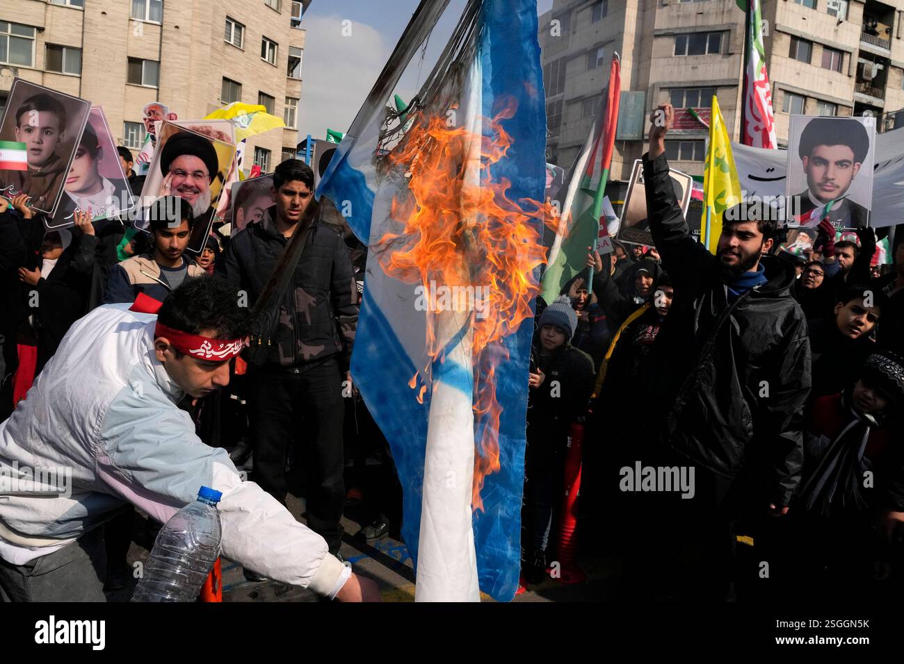 Iranian demonstrators burn a representation of the Israeli flag during ...