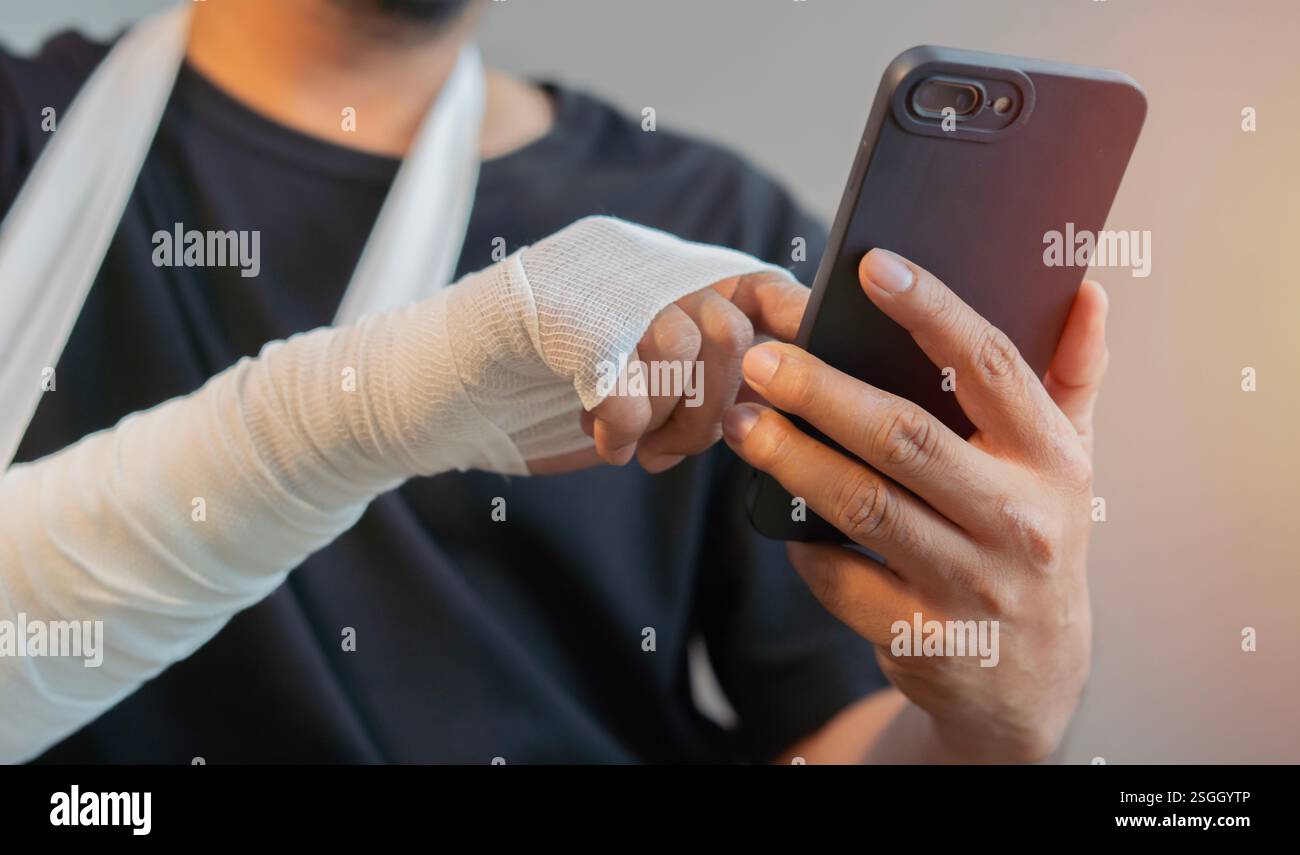 Man with gauze bandage or plaster cast on broken hand, broken wrist use ...