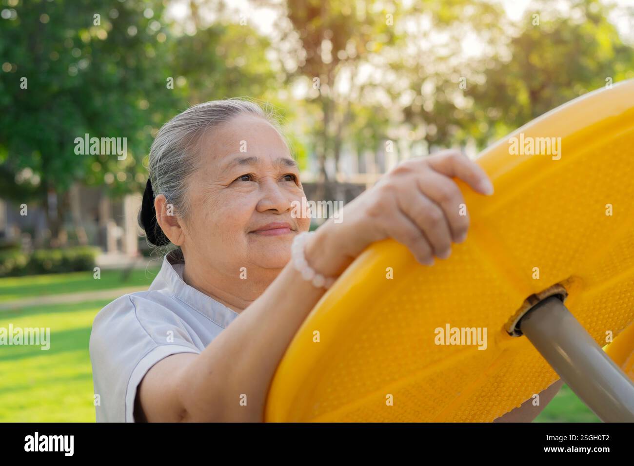 Happy older Asian woman enjoys outdoor exercise. Embracing an active ...