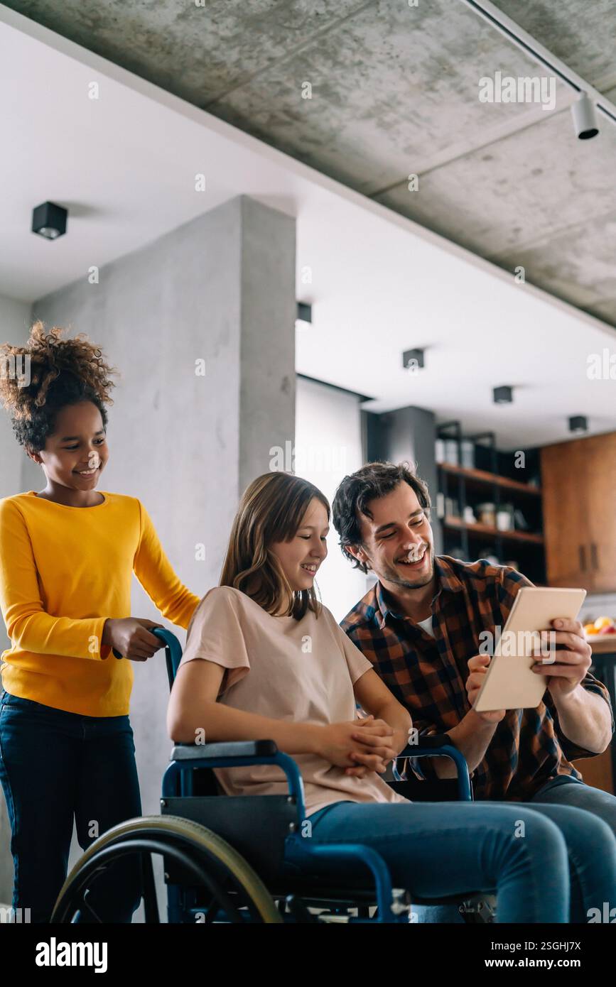 Happy multiethnic family with child with disability in wheelchair Stock ...