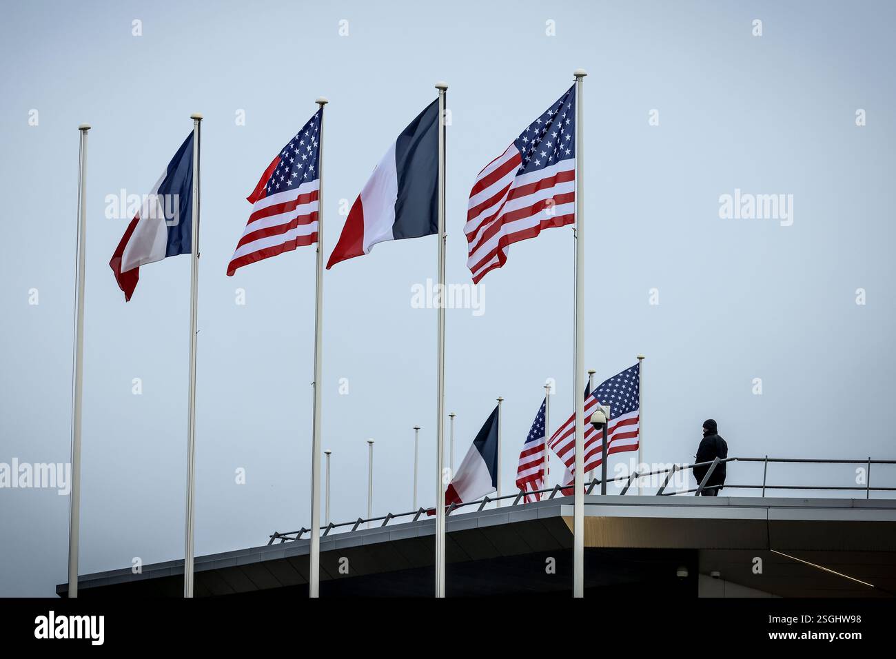French and American flags flap in the wind prior to the arrival of ...