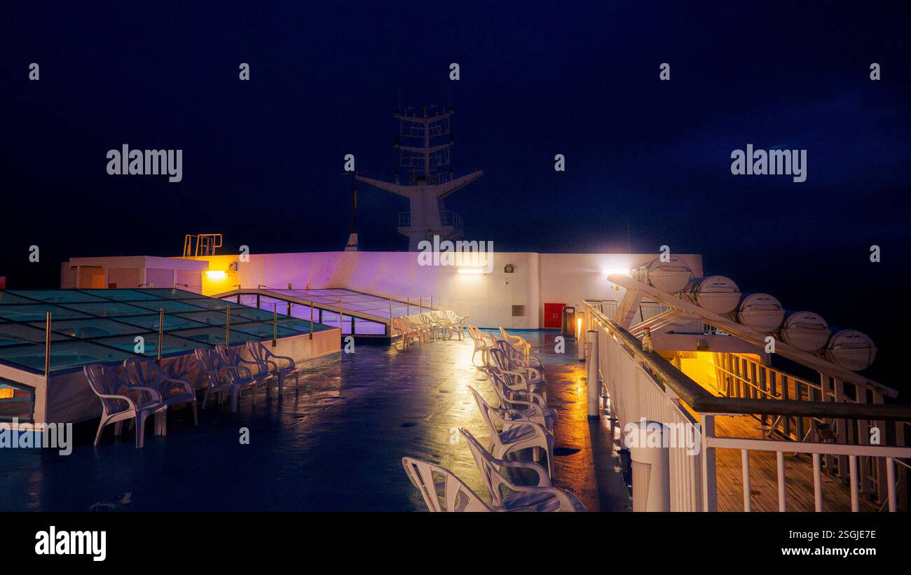 The top deck of a ferry crossing the English Channel at night, with ...