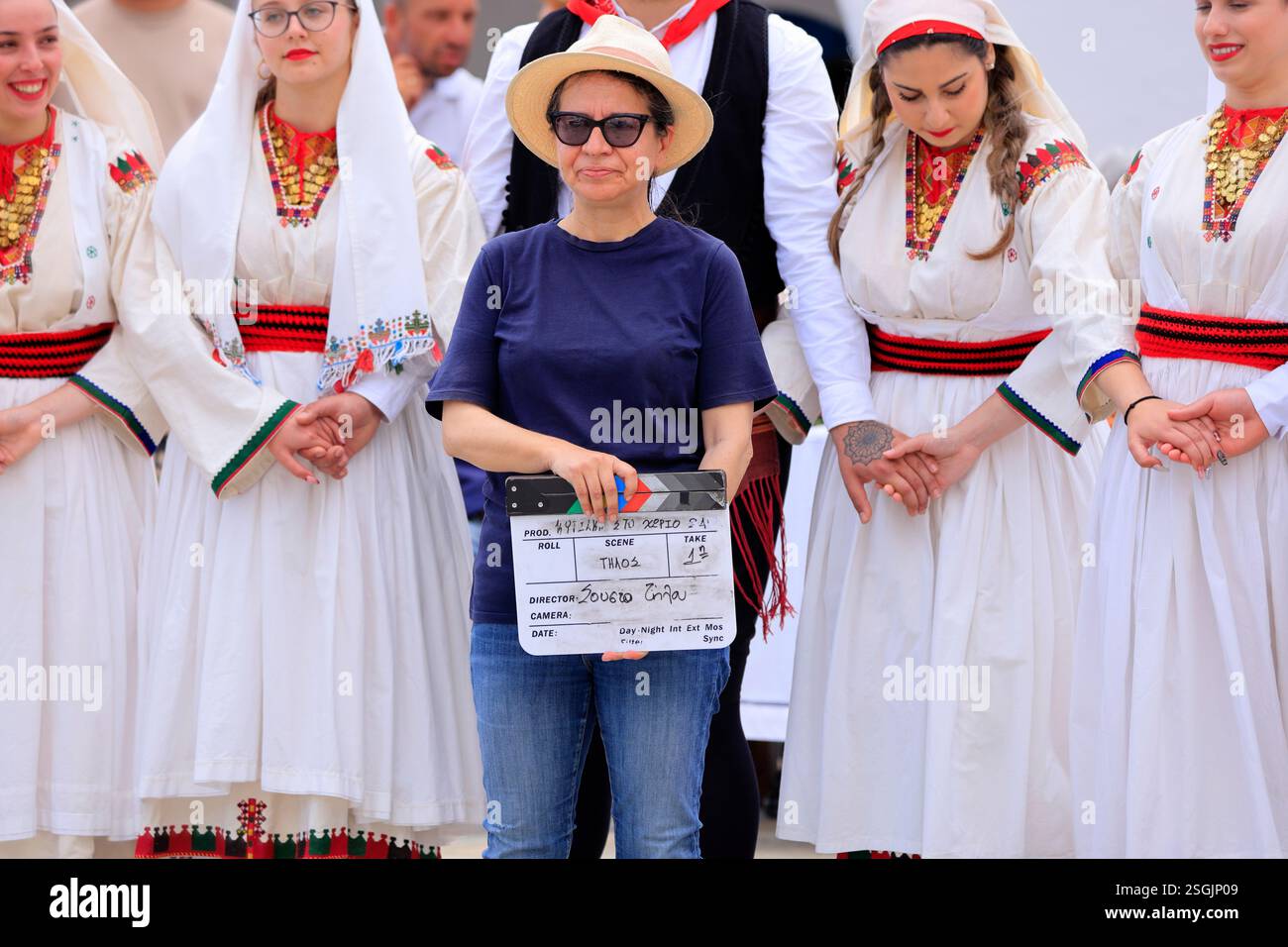 Clapper board operator, Traditional Greek dancers during the recording ...