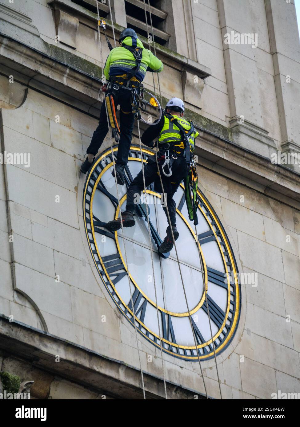 Abseiling rope access technicians at work on the clock tower of St ...