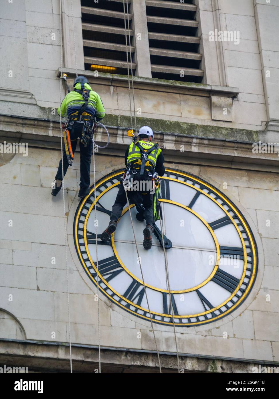 Abseiling rope access technicians at work on the clock tower of St ...