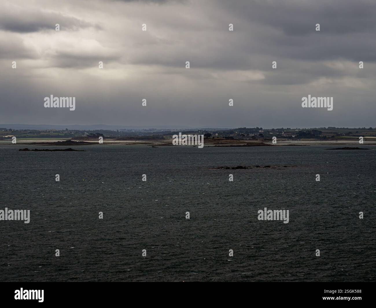 The coast near Roscoff pictured from a departing ferry going across the ...