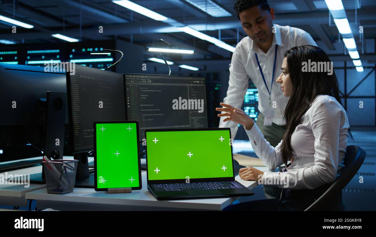 Engineer working with mockup laptop and tablet in data center used for managing gear energy ...