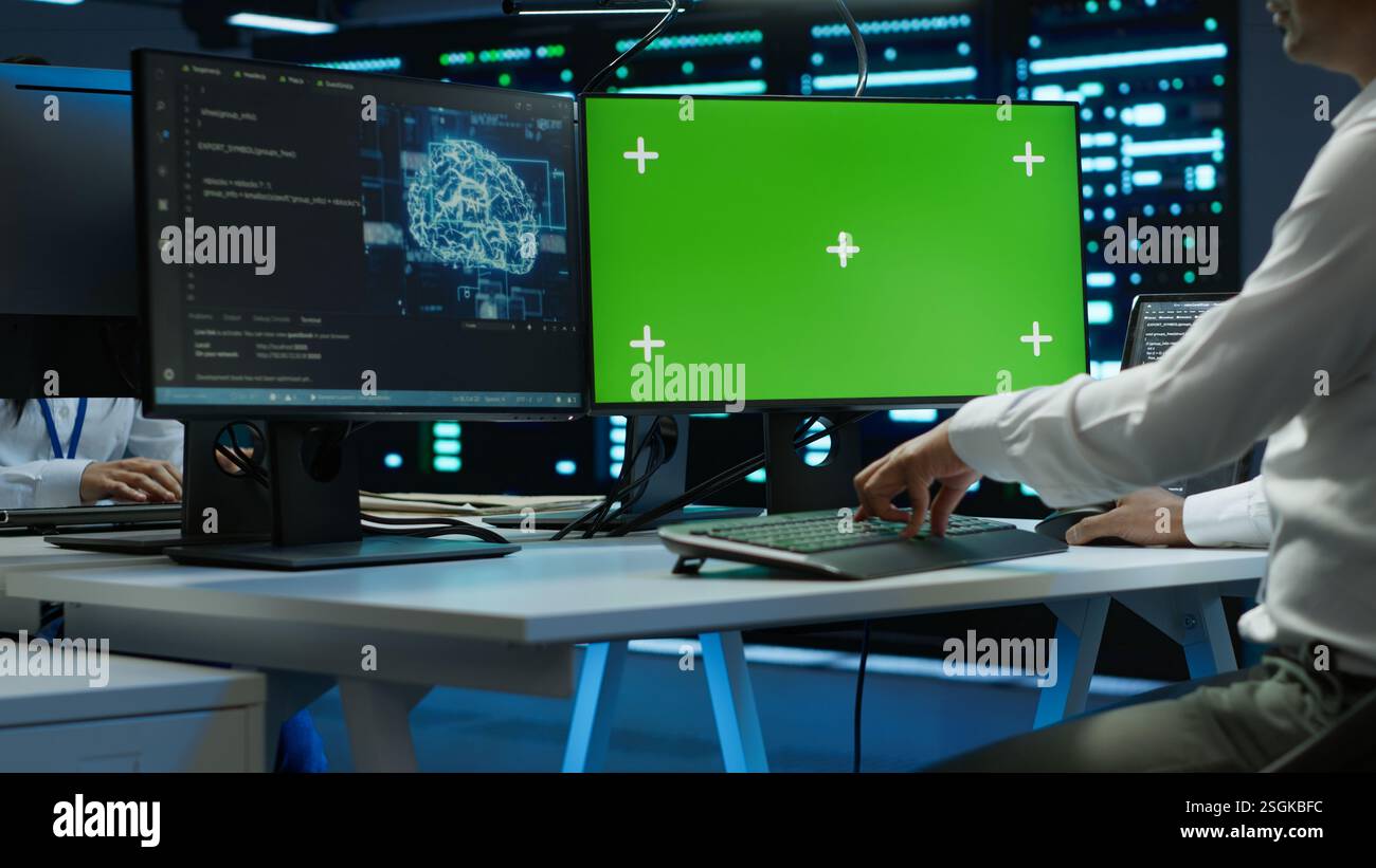 Engineer using AI tech on green screen PC to do checkup in server room. Zoom in of expert in ...
