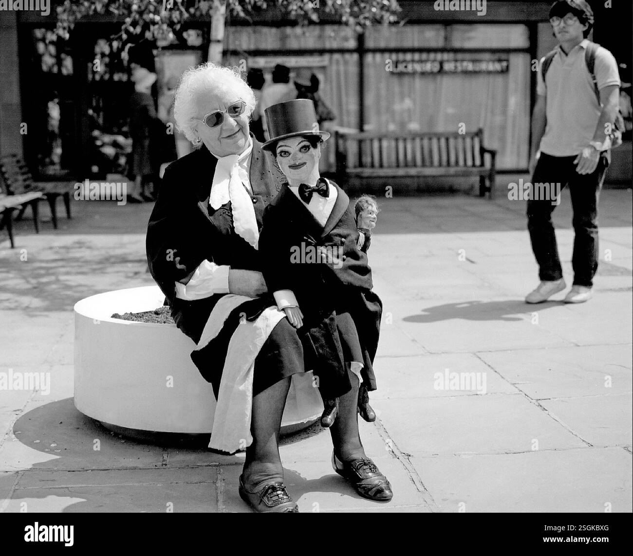 Senior street entertainer woman with puppet on the streets of Stratford ...