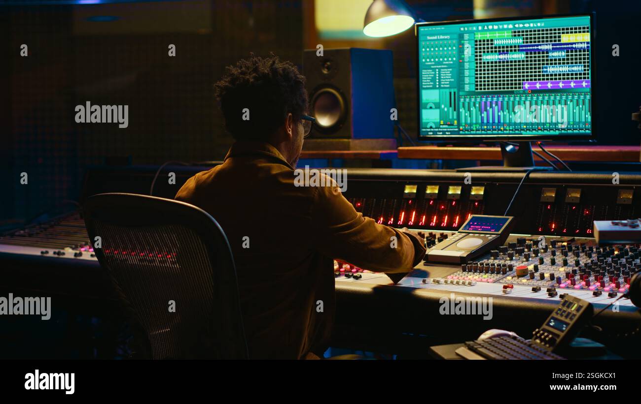 African american audio engineer uses compressor and mixer in ...
