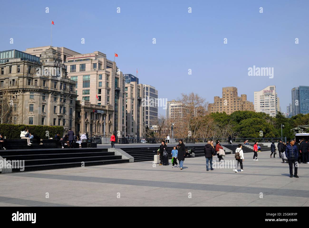 Pedestrians and tourists walking along the Bund in Shanghai, China ...