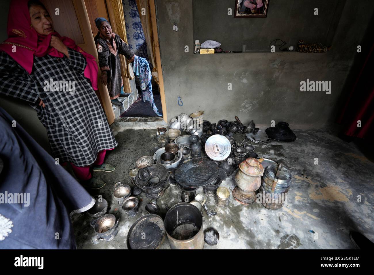 A Kashmiri woman cries near damaged utensils during a fire on ...