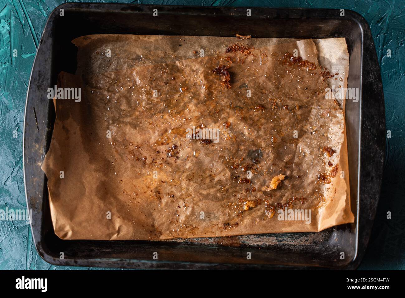 Baking tray with used baking paper. The texture of dirty parchment on a ...