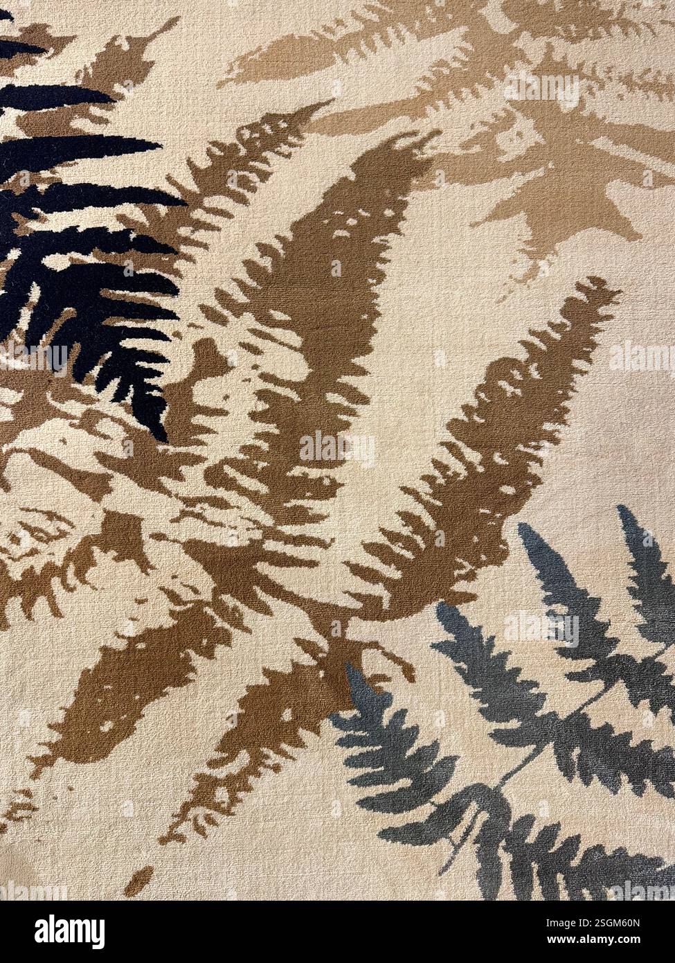 Close up of carpet rug with palm leaves pattern in shades of brown ...