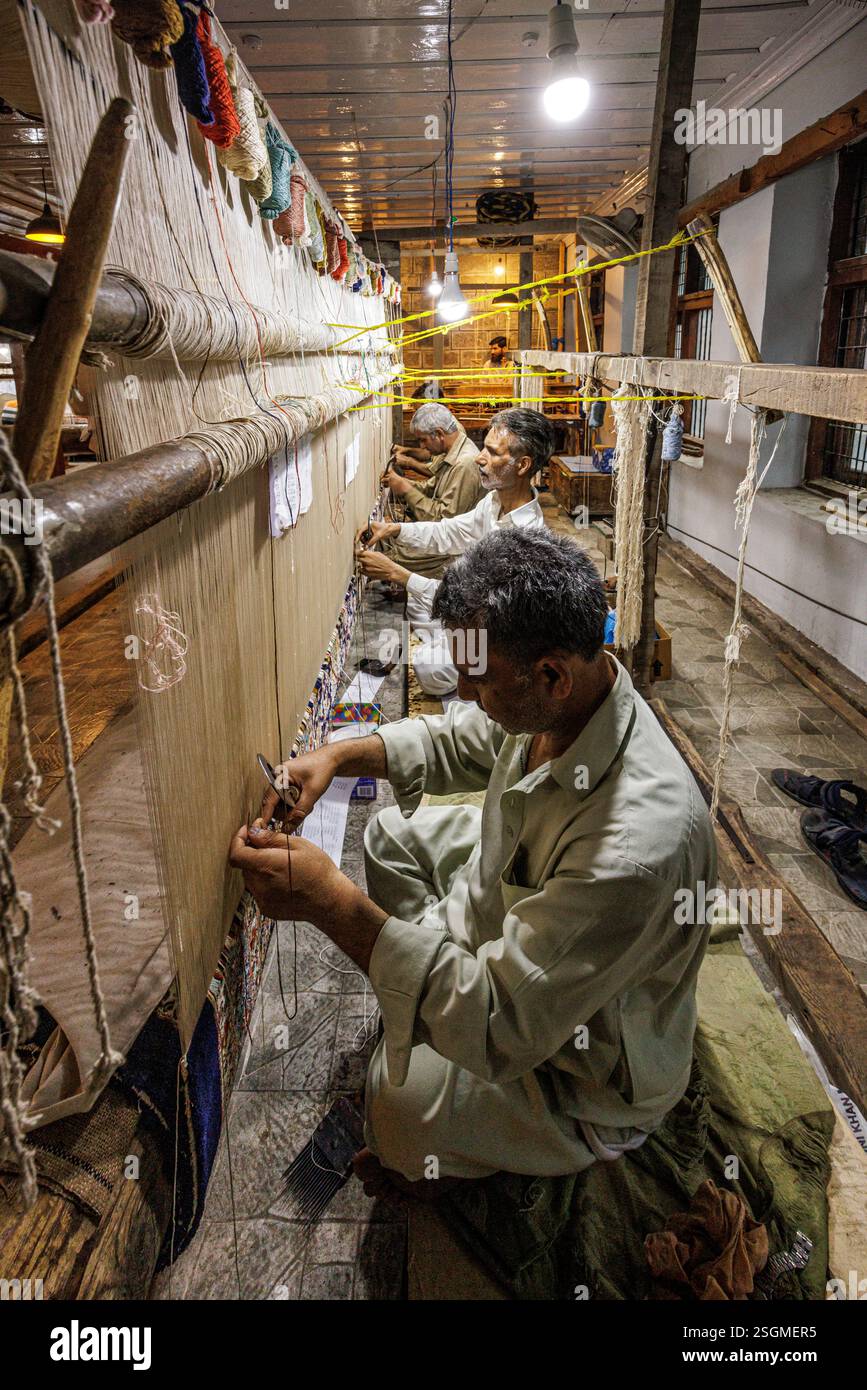 Carpet-making, Srinagar, Kashmir, India, 2023. Men weaving a large ...