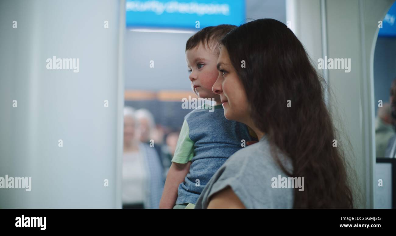 TSA Security Line in Airport Terminal: Woman with Kid Walking Through X ...