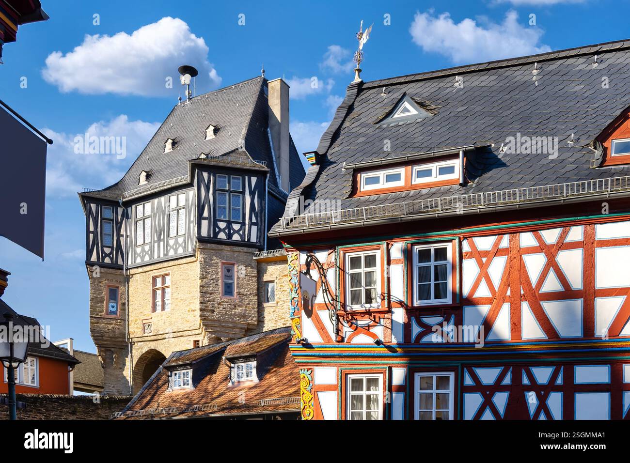 Picturesque view of colorful half-timbered houses and a medieval Castle ...