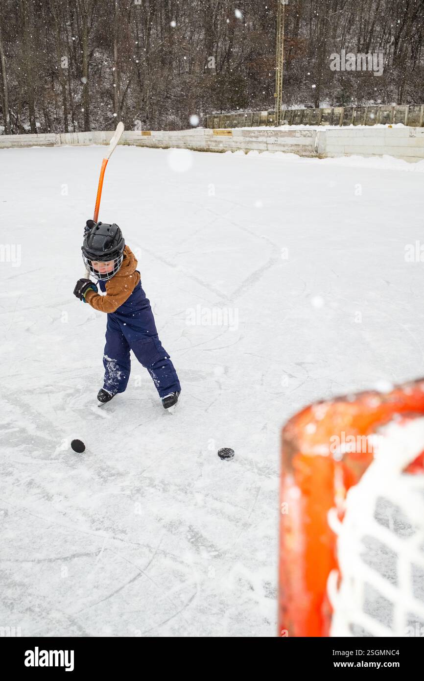 Child Playing Hockey on Outdoor Ice Rink with a Goal in View Stock ...