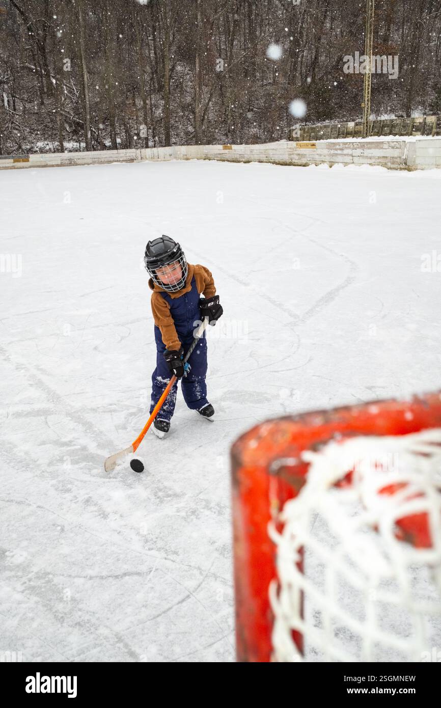 Child Playing Hockey on Outdoor Ice Rink with a Goal in View Stock ...