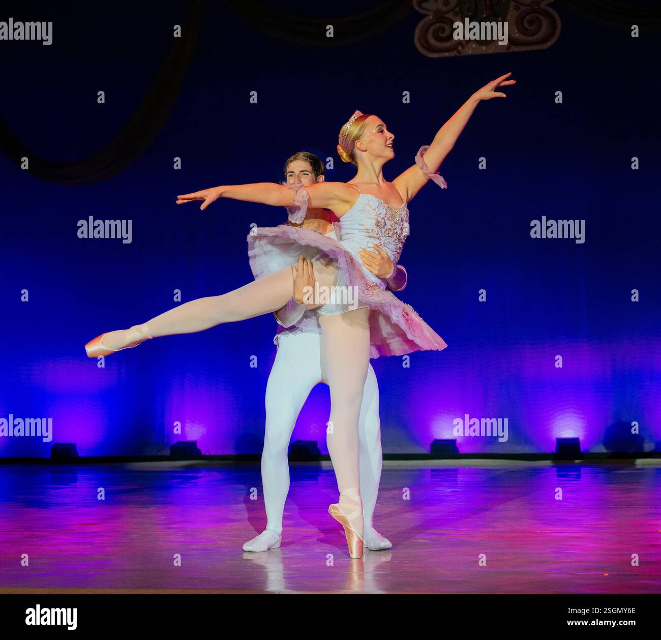 Ballet dancers performing on stage in elegant costumes with a vibrant ...