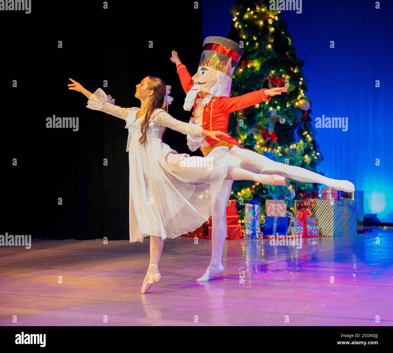 Ballerina dancing with a performer in a nutcracker costume on a festive ...