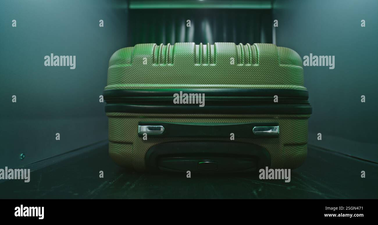 Security Checkpoint in Airport Terminal: Close Up of Suitcase Moving on Conveyor Belt Inside ...