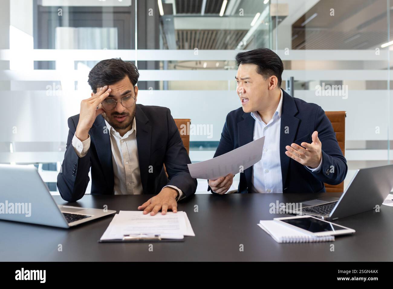 Dissatisfied and frustrated boss yelling at subordinate inside office ...