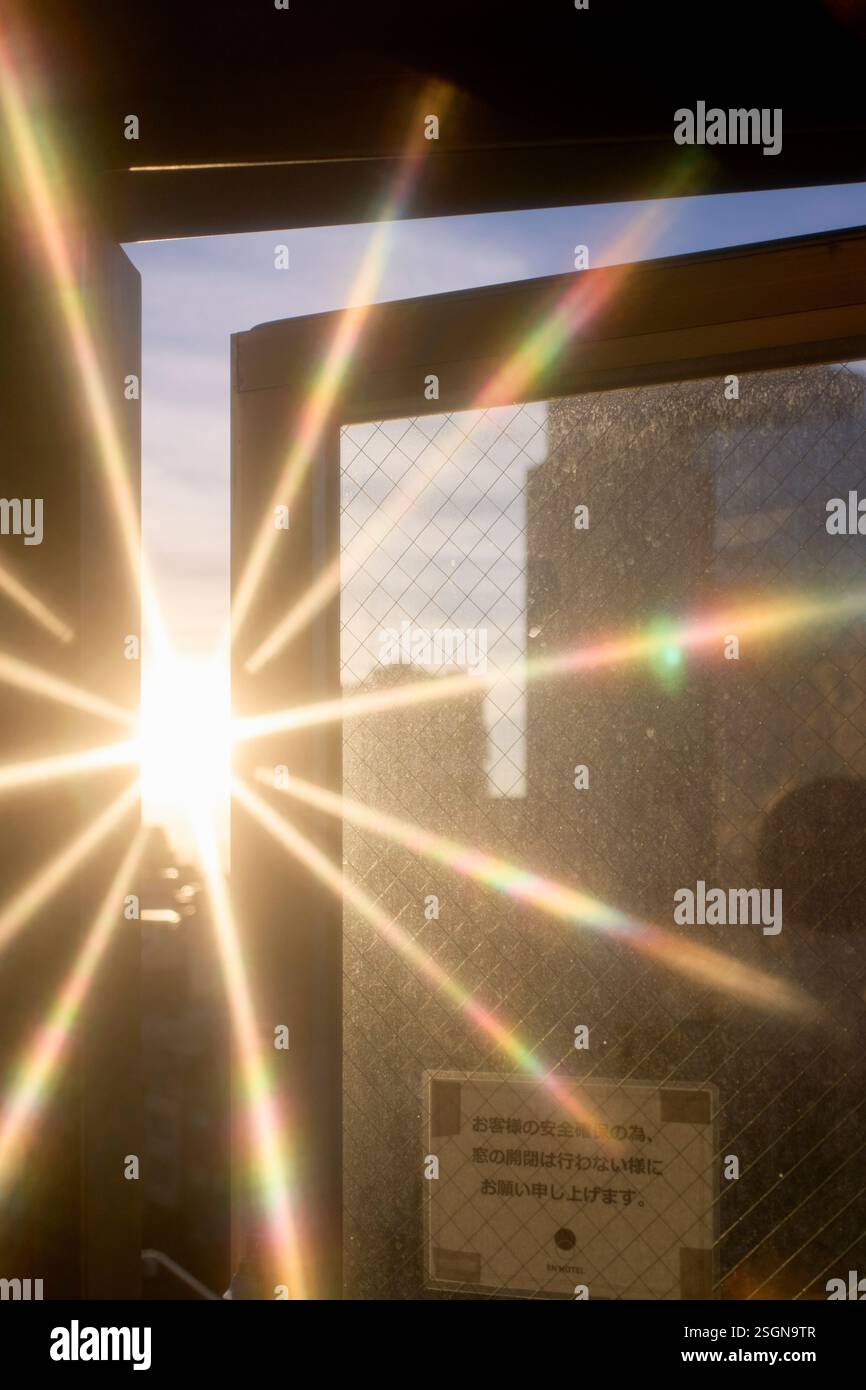 Sunlight streaming through an open window creates a starburst effect on ...