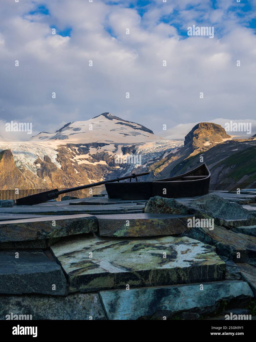 Large metal boat with single oar against background of snow covered ...