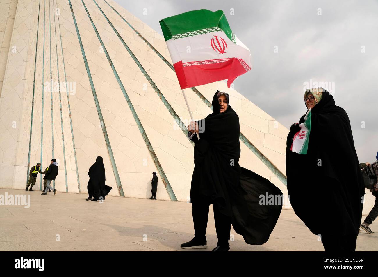 Women carry Iranian flags under the Azadi (Freedom) monument tower ...