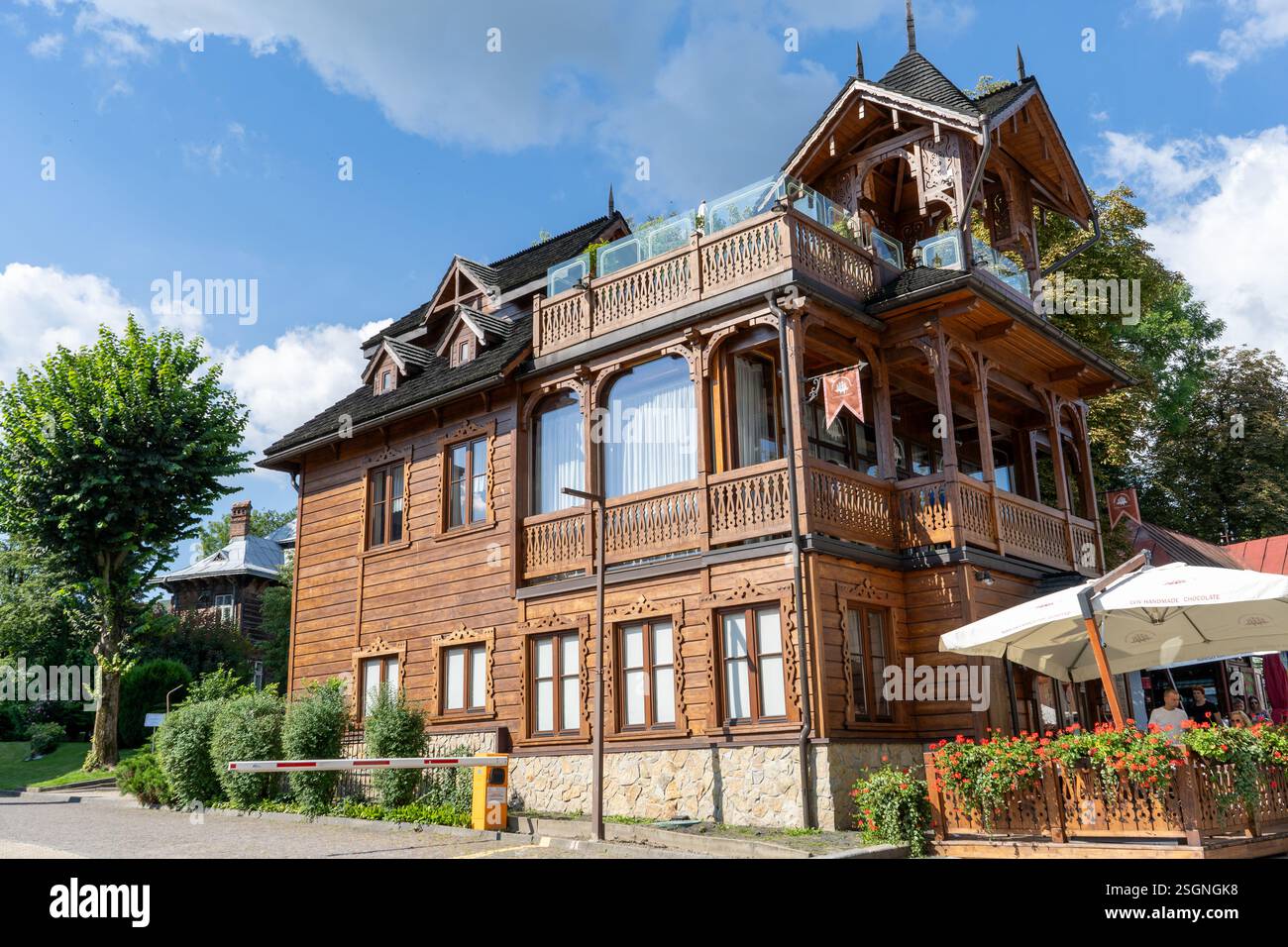 Wooden balcony of a wood house. Exterior facade windows. Old ...
