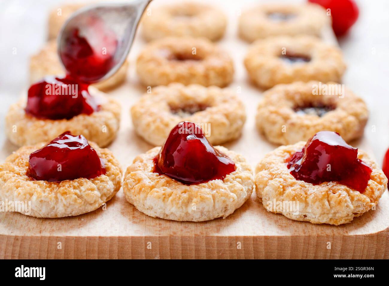 Puff pastry cookies filled with cherry jam. party dessert Stock Photo ...