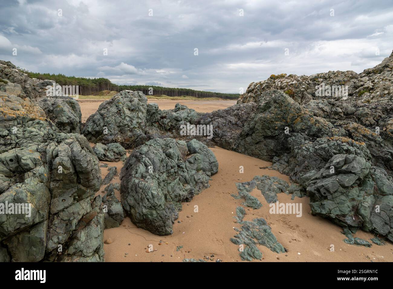 Rock forms on Newborough beach on Anglesey, North Wales Stock Photo - Alamy