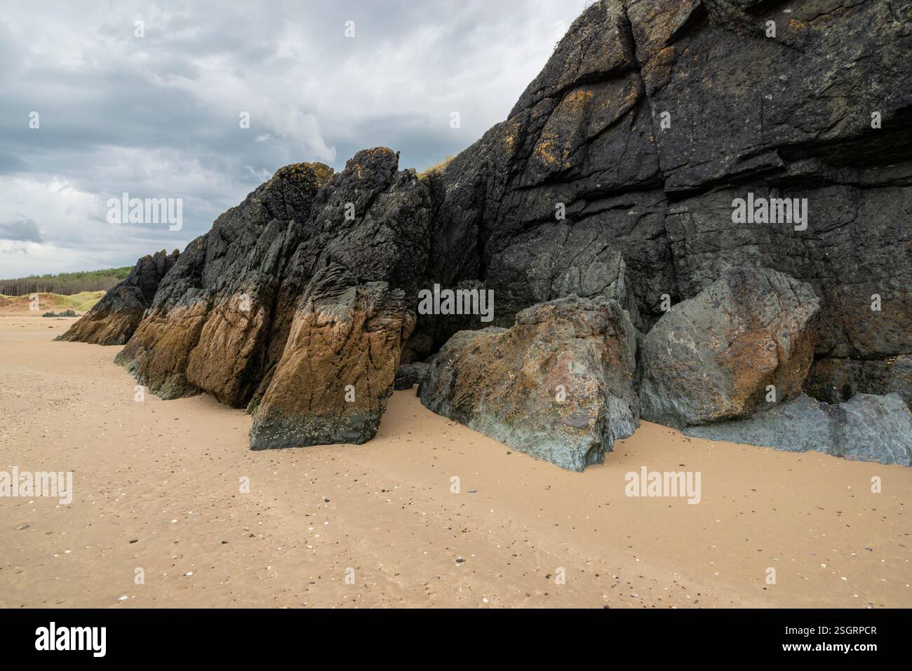 Rock forms on Newborough beach on Anglesey, North Wales Stock Photo - Alamy