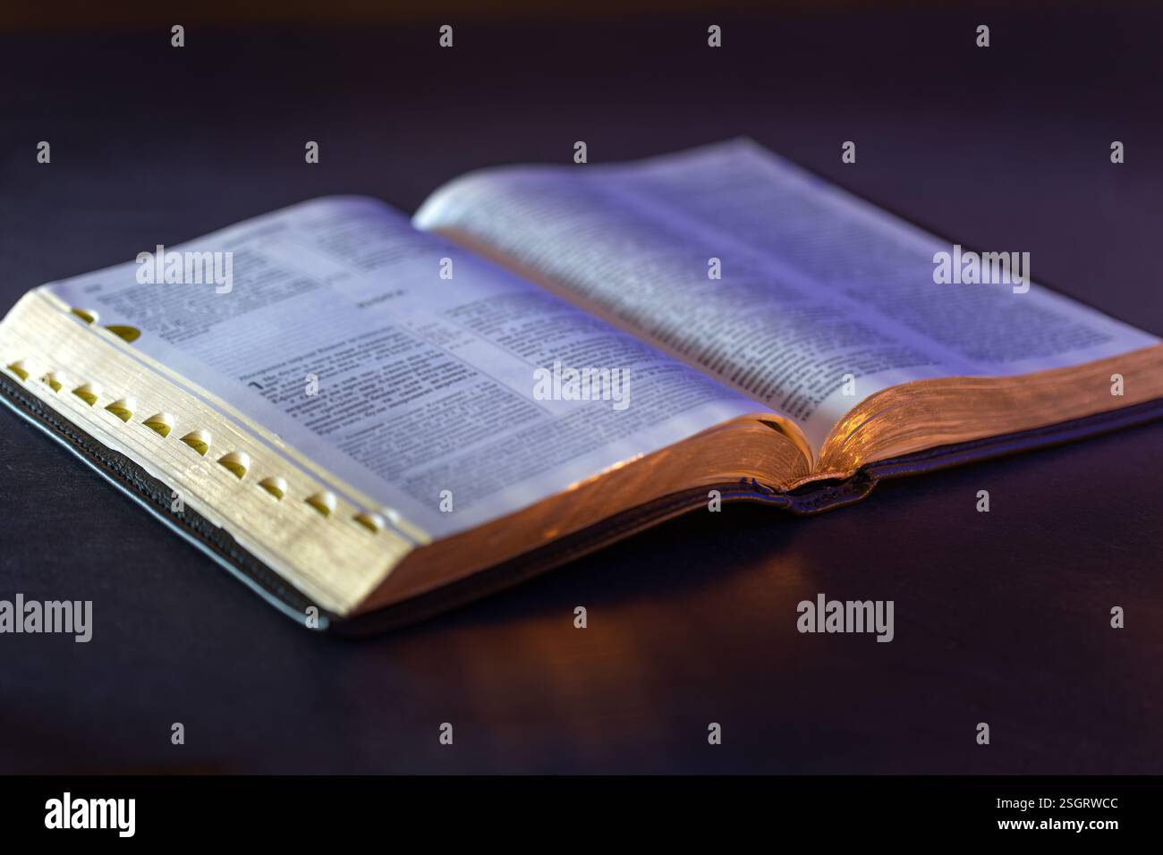 Open Holy Bible on the table. Religion concept. Bible on black ...