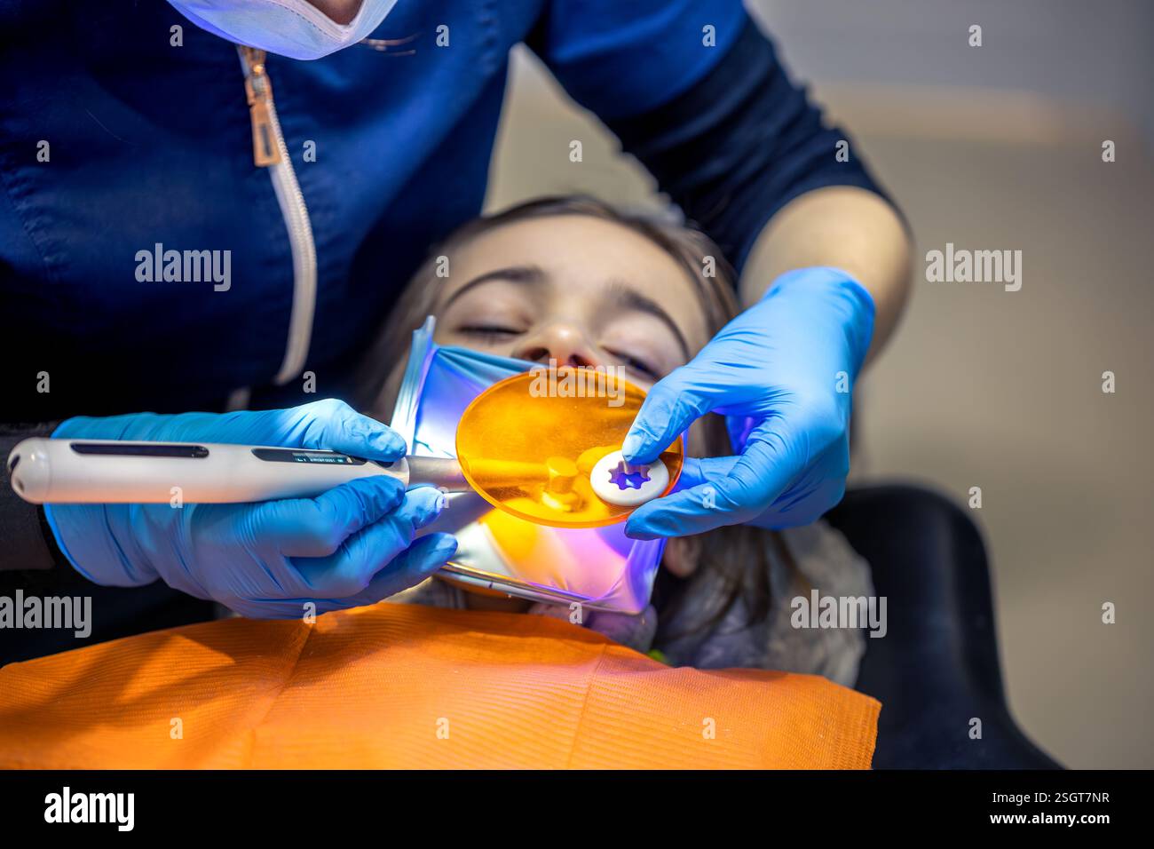 Dental fillings. Dental fillings with ultraviolet light. Female dentist ...